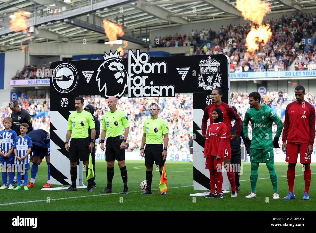 Players and officials stand next to the No Room For Racism sign before ...
