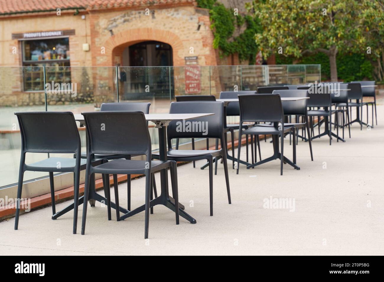 Plastic tables and chairs in a cafe empty in the morning, without ...