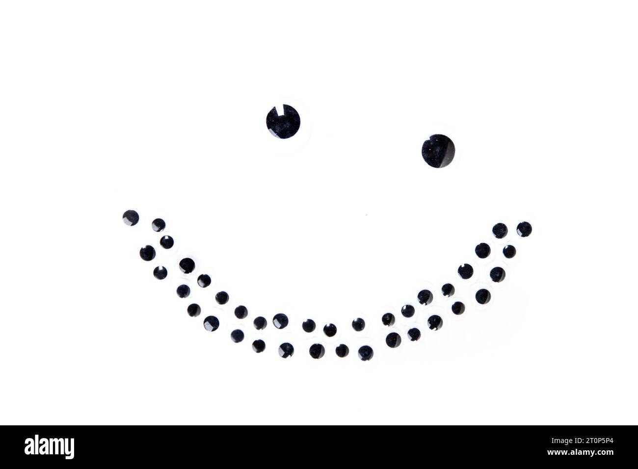 Lopsided smile face made of round black dots isolated over white Stock ...