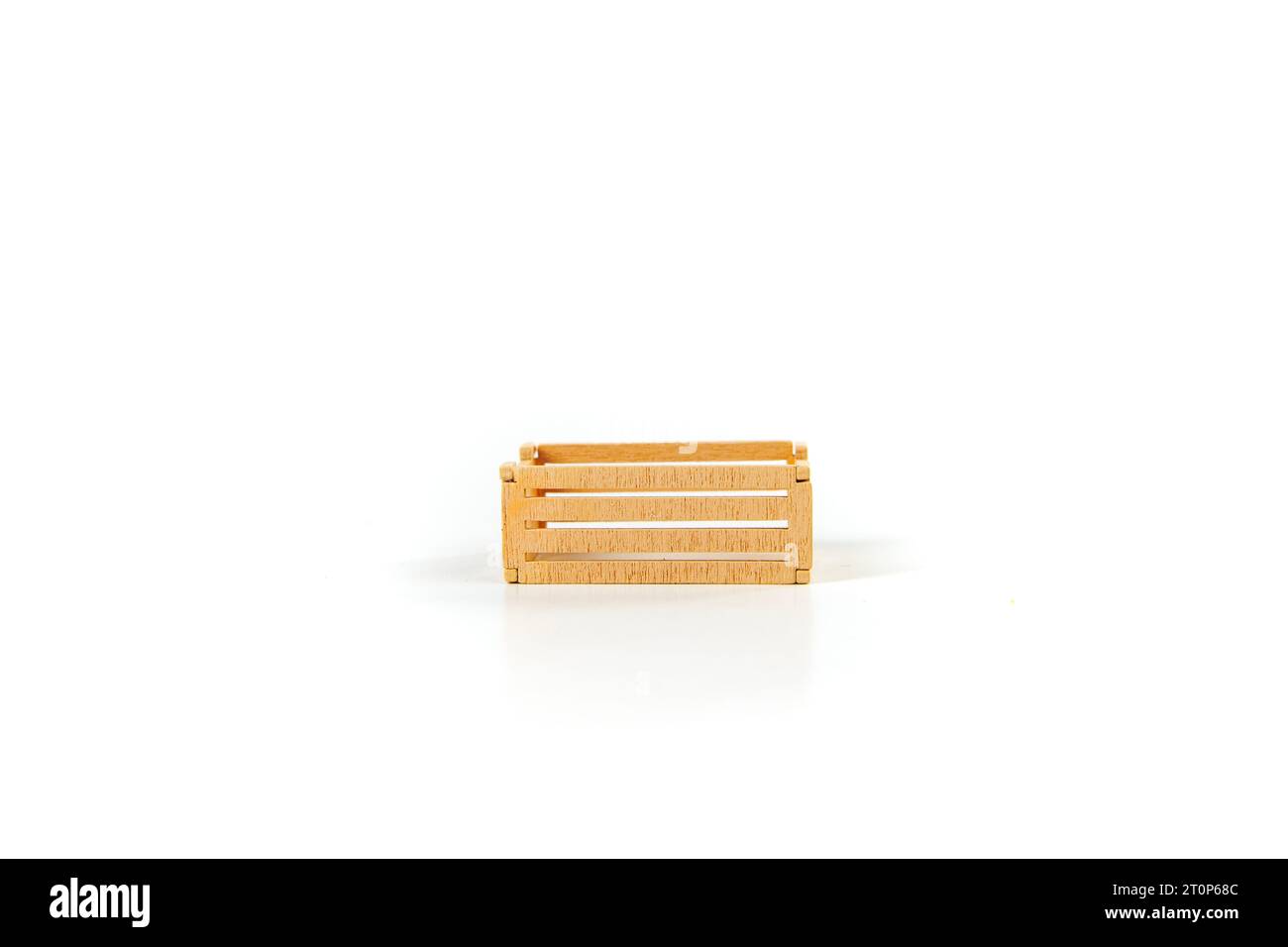 Tiny wooden doll apple box isolated over white Stock Photo - Alamy