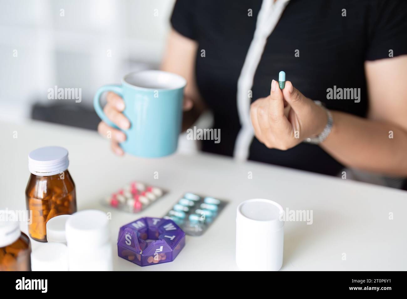 Sick illness woman hold pill on hand pouring capsules and glass take ...