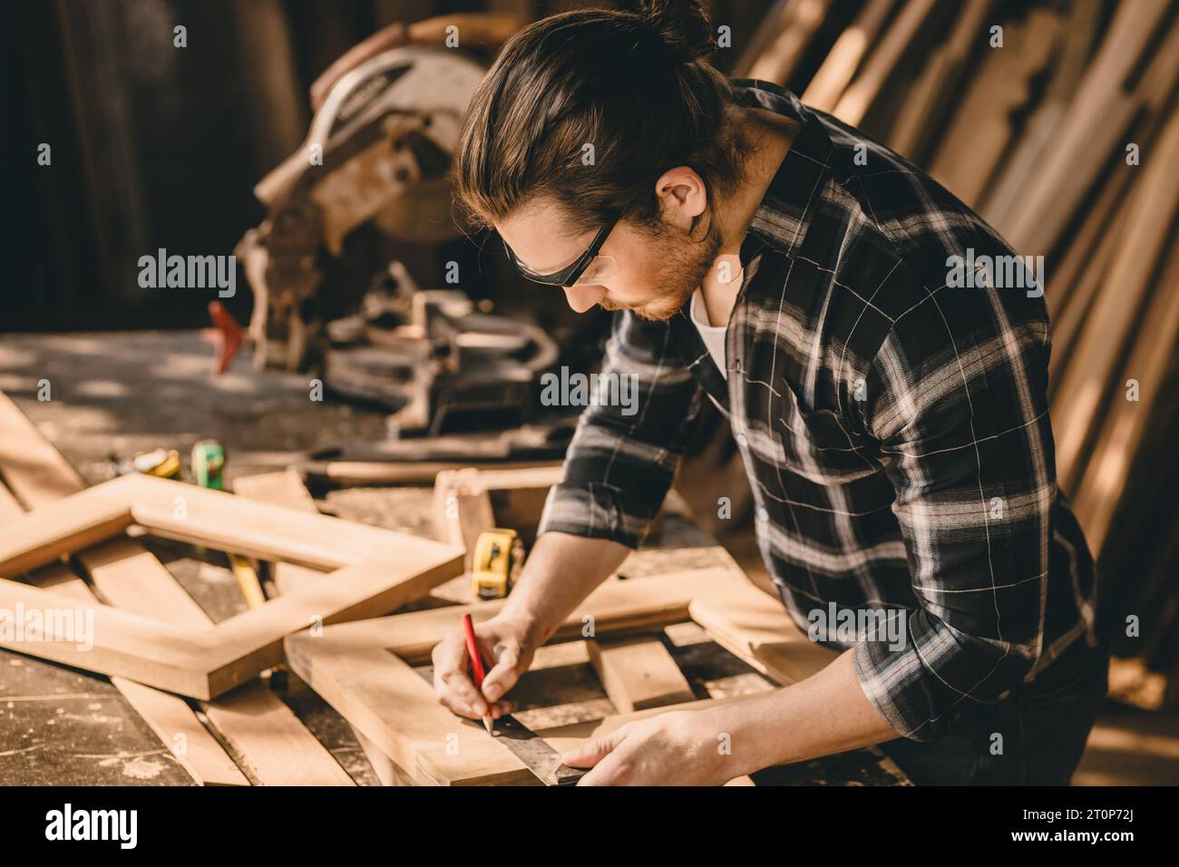 Carpenter Joiner man making wooden furniture in wood workshop ...