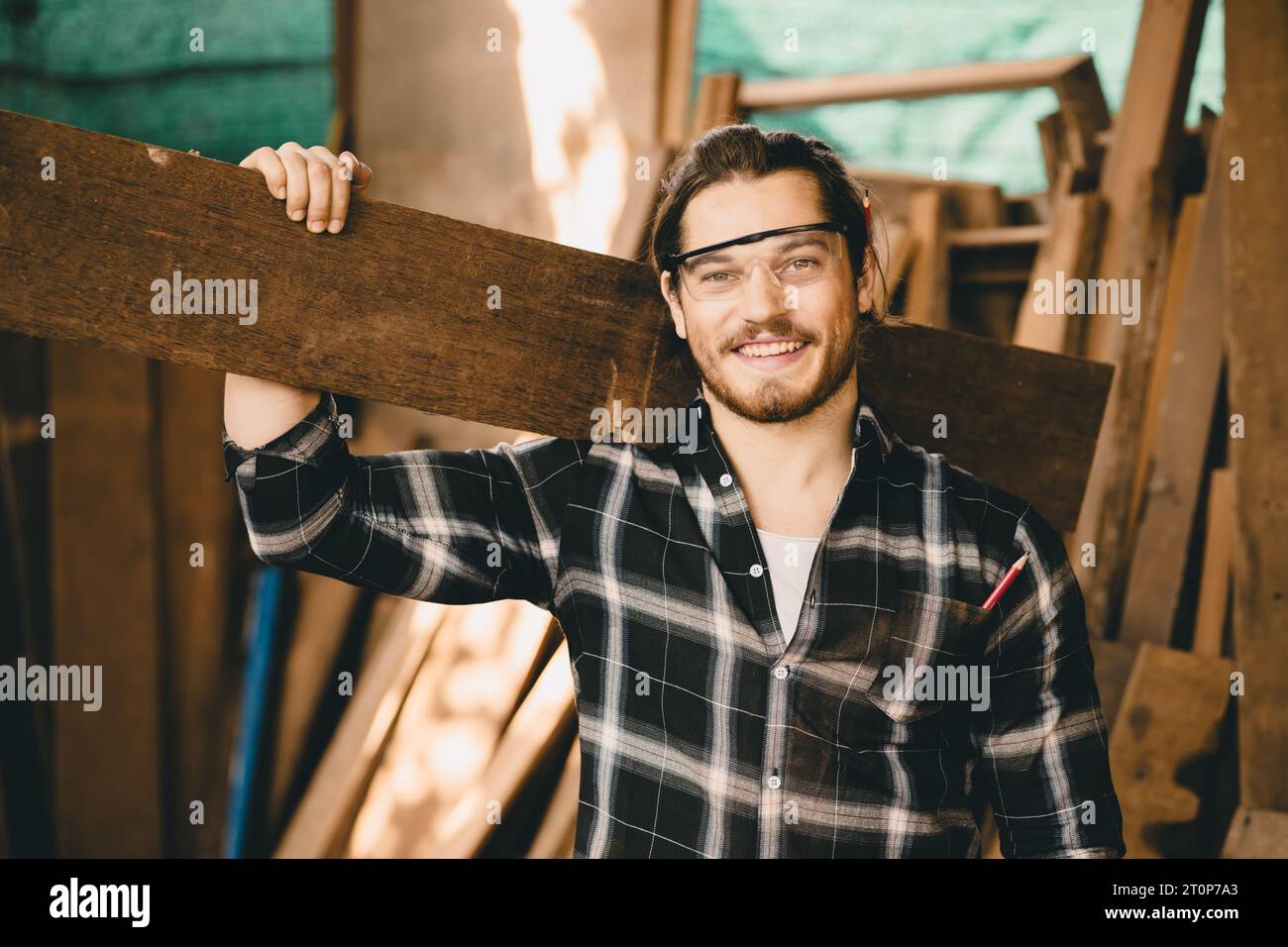 Portrait young carpenter artisan hand wood crafting man with wooden ...