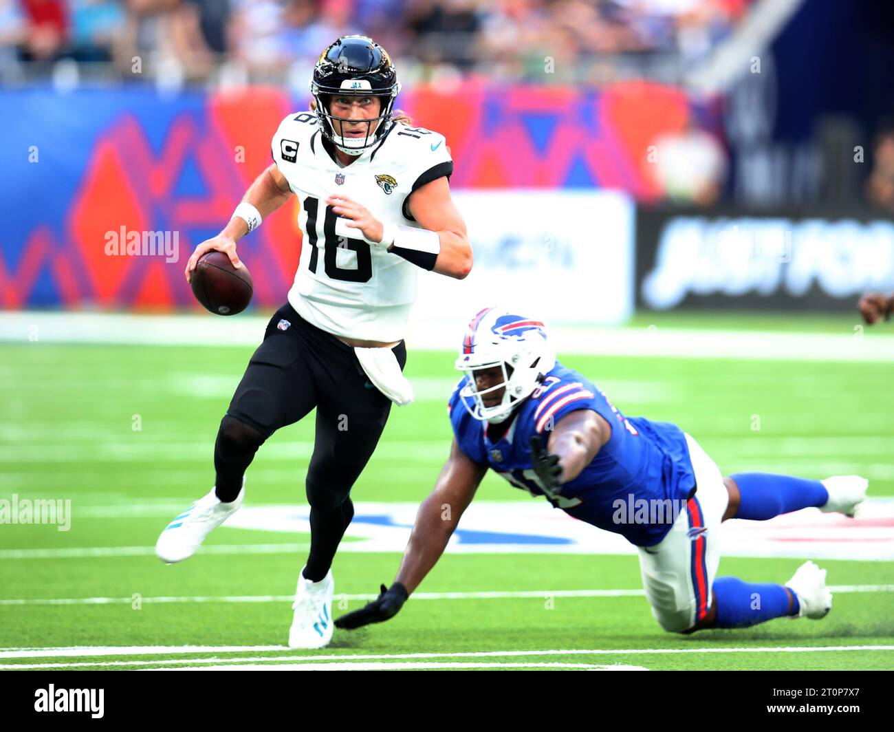 Jacksonville Jaguars Trevor Lawrence gets away from pressure after the ...