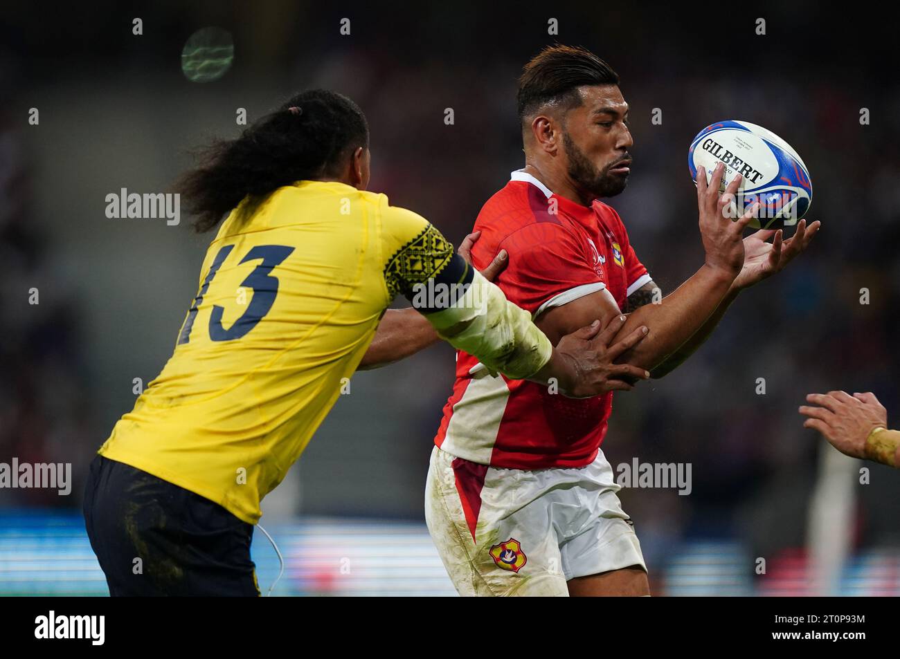 Romania's Tevita Manumua (left) and Tonga's Siale Piutau in action ...