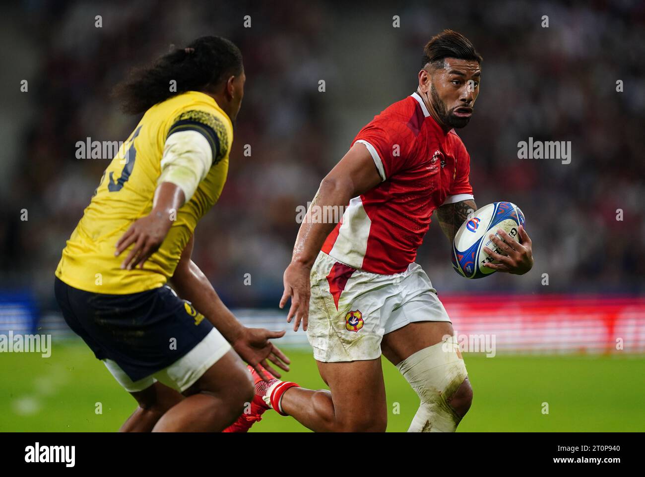 Romania's Tevita Manumua (left) and Tonga's Siale Piutau in action ...