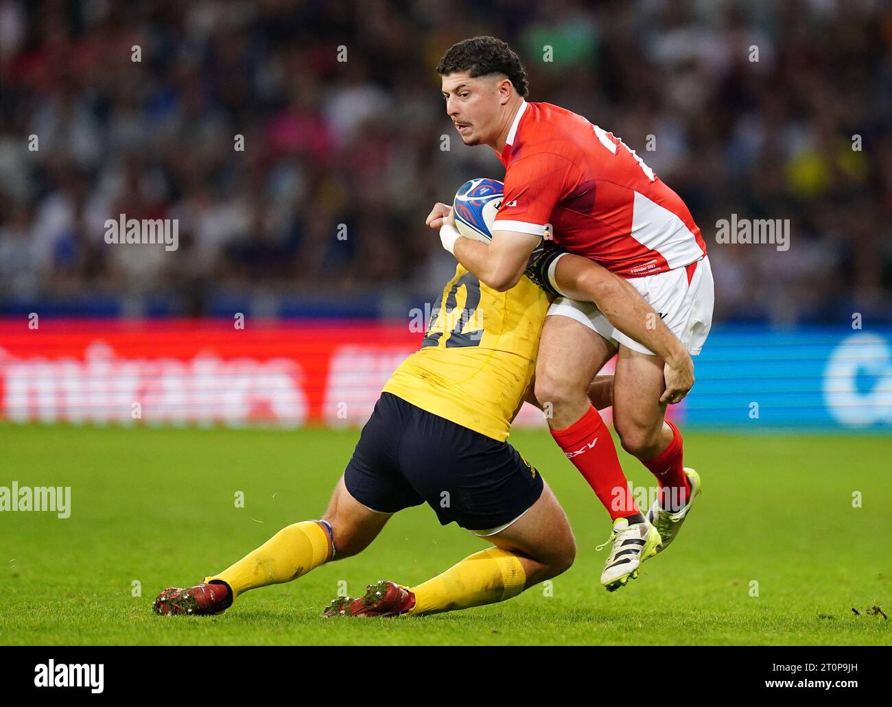 Romania's Alexandru Bucur (left) tackles Tonga's Patrick Pellegrini ...