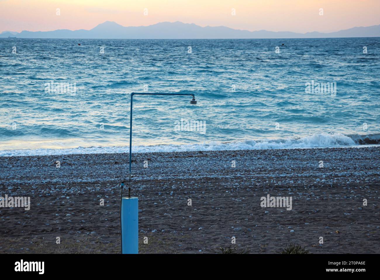 Outdoor beach shower in front of the ocean at Paralia Ixia beach during ...