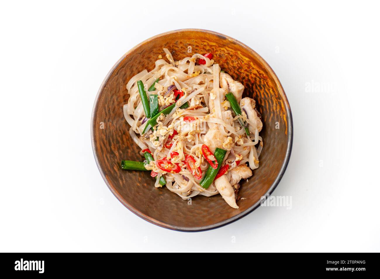 Pad Thai Udon noodles in in a brown plate, top view isolated. Food in ...