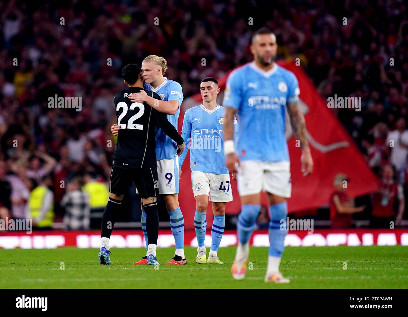 Arsenal goalkeeper David Raya (left) hugs Manchester City's Erling ...