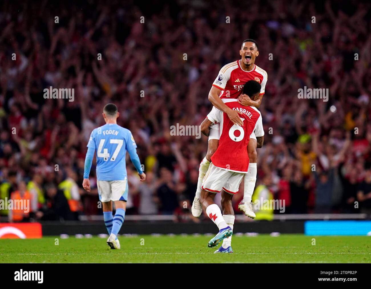 Arsenal's William Saliba (top) and Gabriel celebrate at the end of the ...