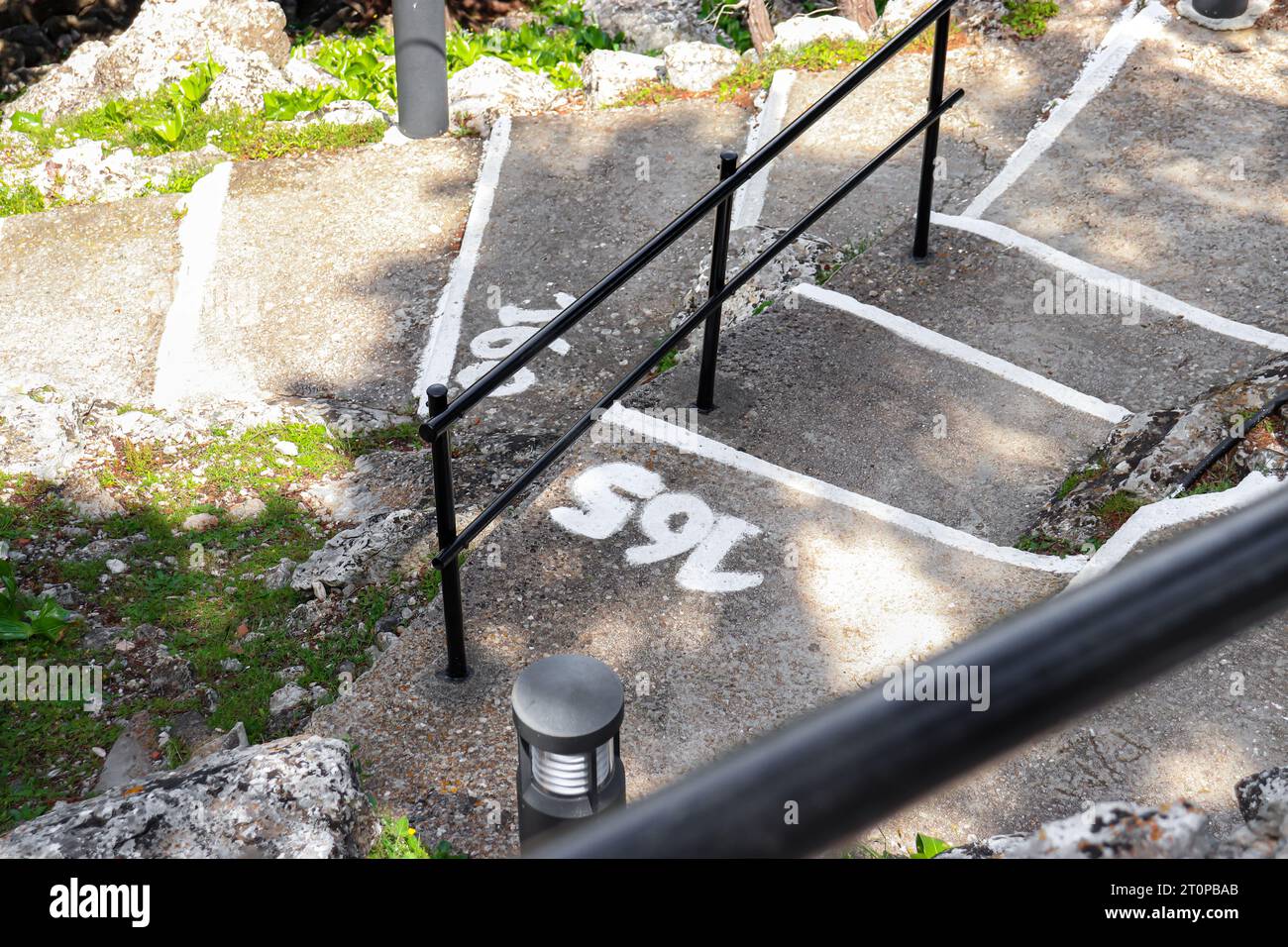 White painted stone stairs numbered 165 out of 300 leading up to the ...