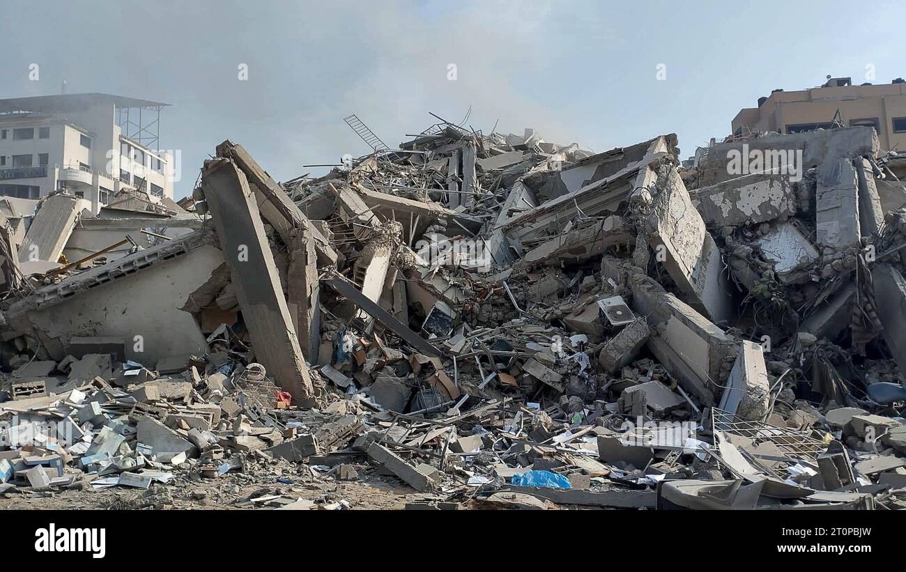 Gaza, Palestine. 8th Oct, 2023. (INT) Palestinians inspect the ruins of ...