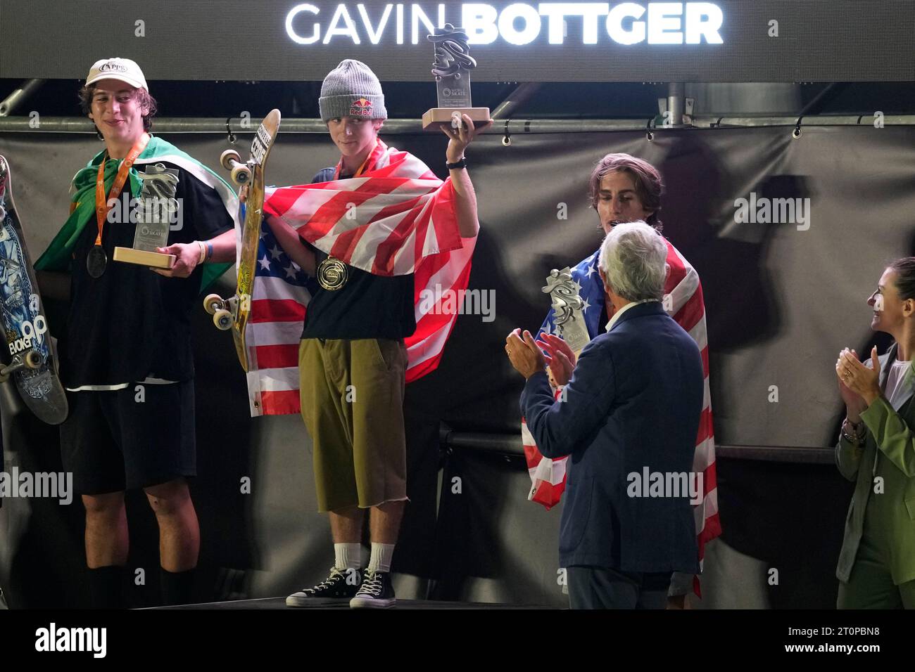 Gavin Bottger of the United States, center, holds his trophy on the ...