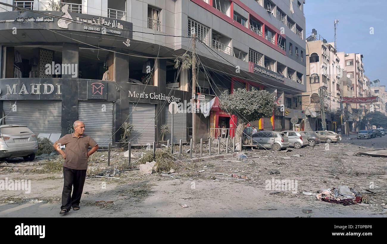 Gaza, Palestine. 8th Oct, 2023. (INT) Palestinians inspect the ruins of ...