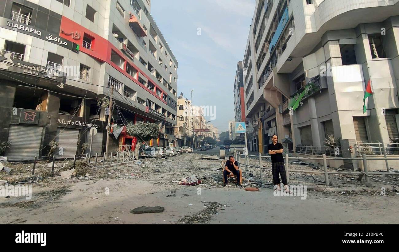 Gaza, Palestine. 8th Oct, 2023. (INT) Palestinians inspect the ruins of ...