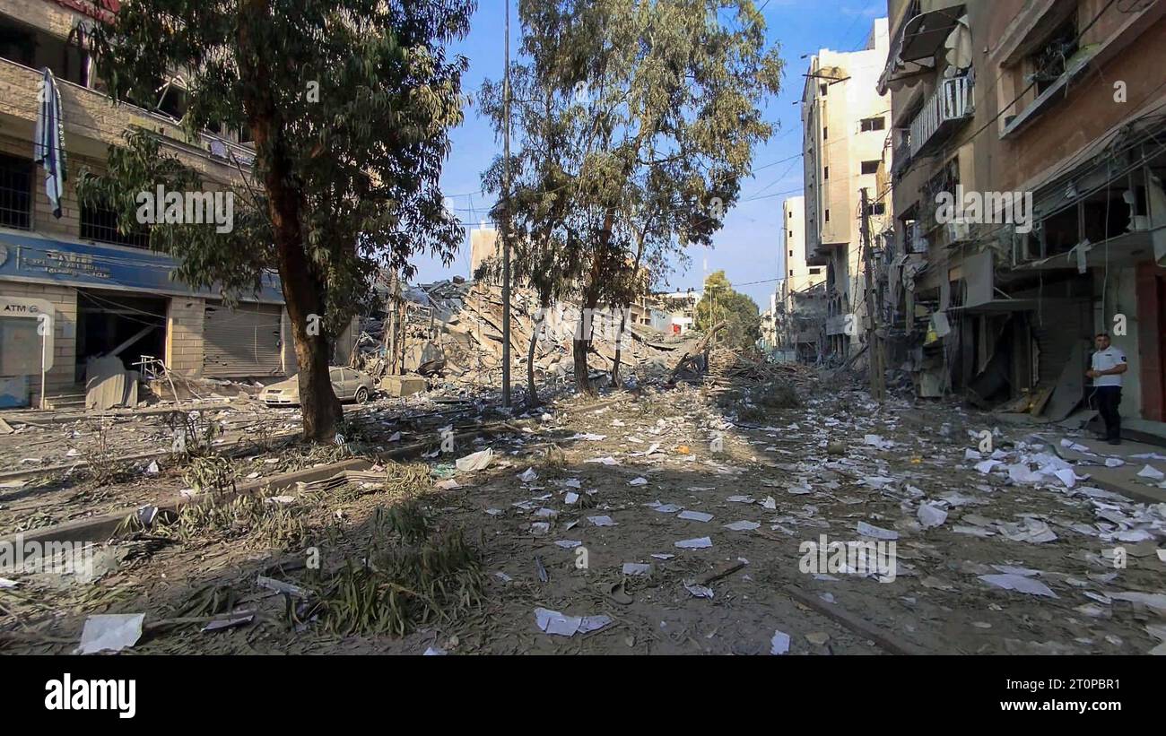 Gaza, Palestine. 8th Oct, 2023. (INT) Palestinians inspect the ruins of ...