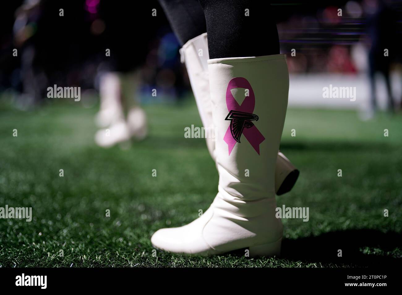 A pink ribbon is seen on the boot of an Atlanta Falcons cheerleader in ...