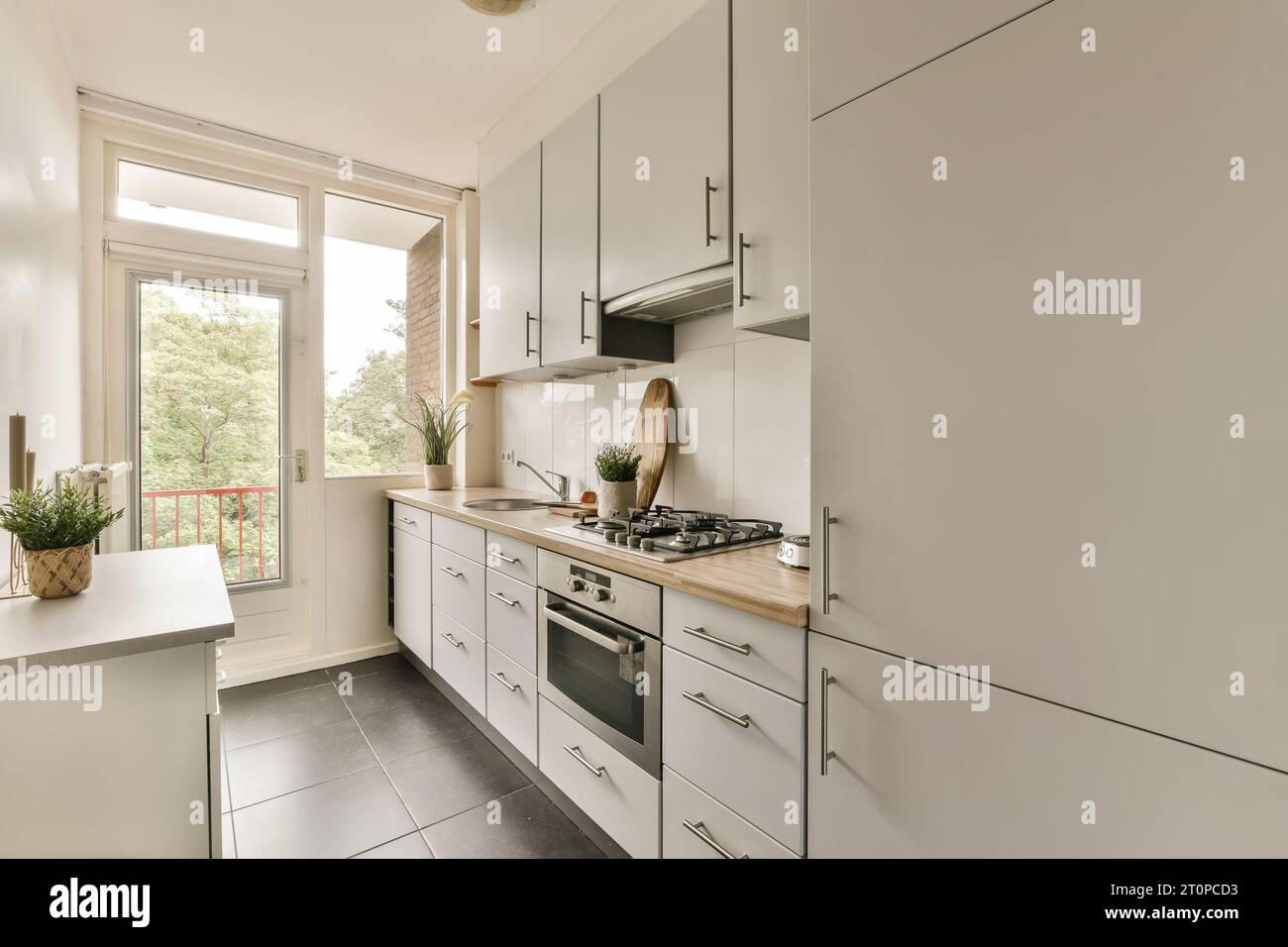 a kitchen with white cabinets and wood counter tops on the counters in ...