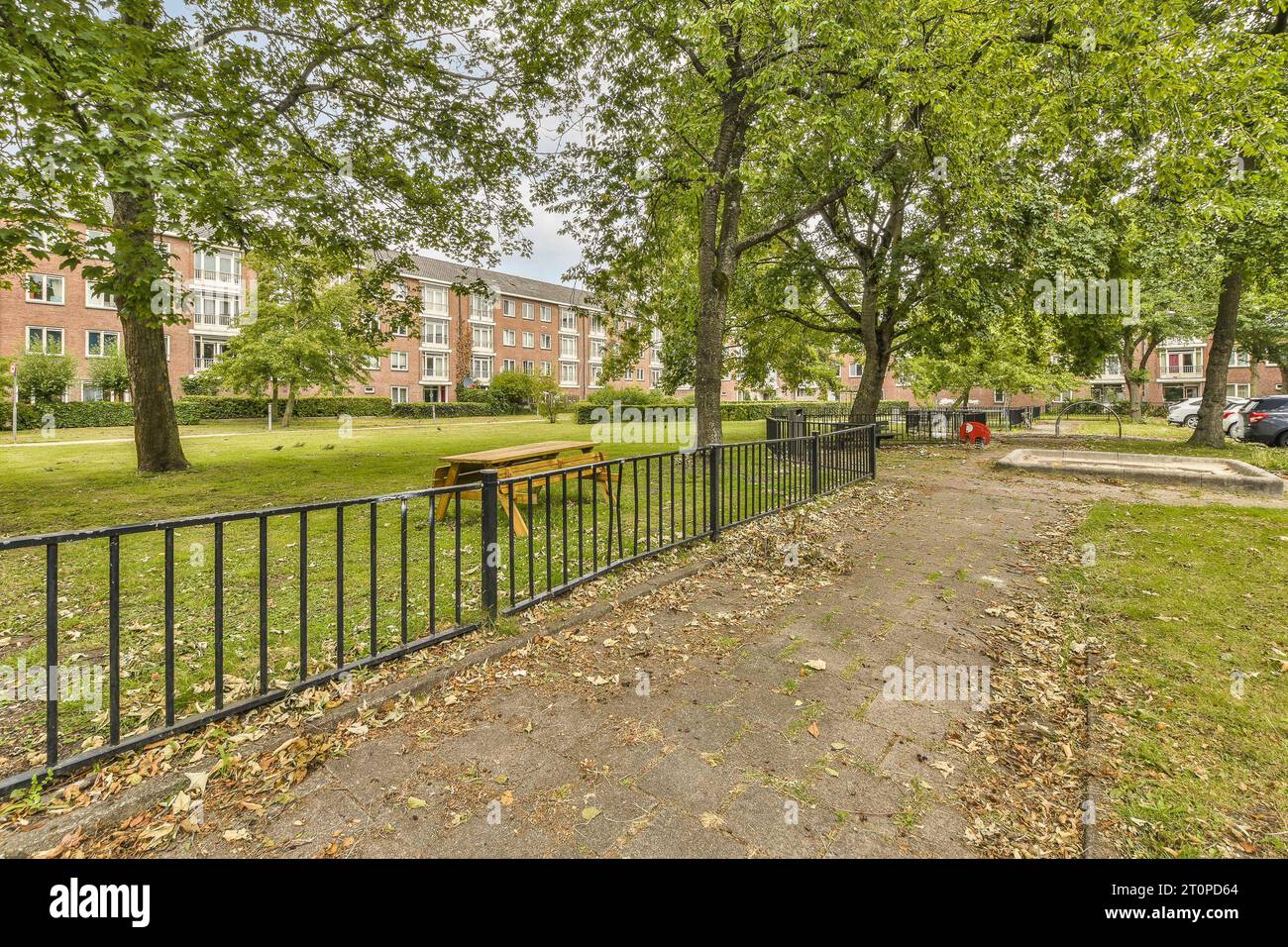 an empty park with trees and benches in the fore - image taken from ...