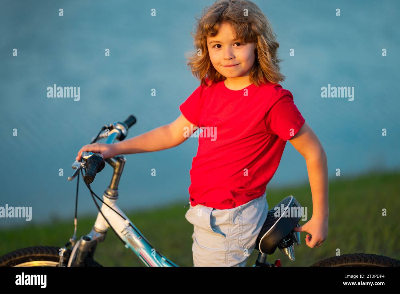 Child riding bicycle. Little kid boy on bicycle along bikeway. Happy ...
