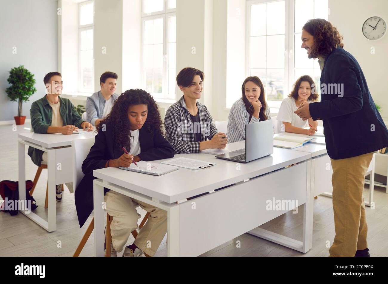 Male teacher conducts lesson for high school students and discusses ...
