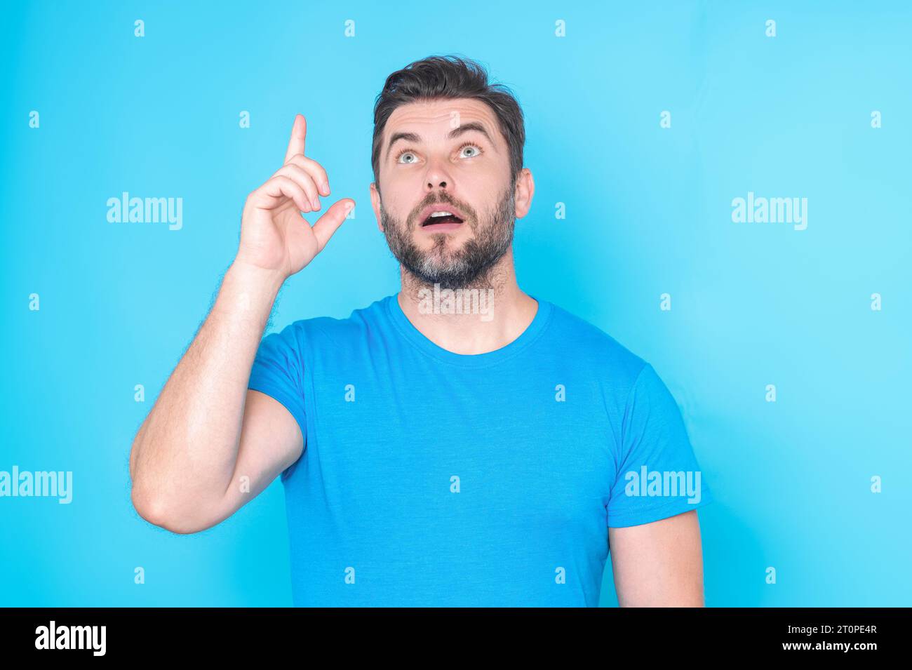 Surprised man thinking of idea on studio background. Portrait of man ...
