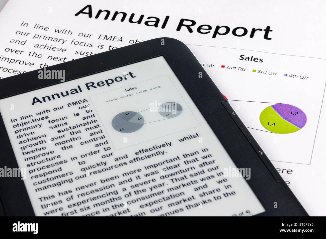 E-reader showing a company annual report with a printed copy Stock ...