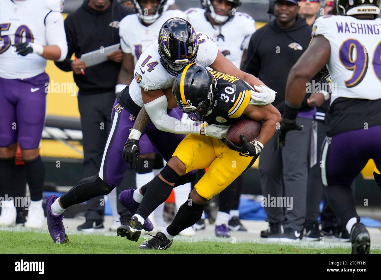 Baltimore Ravens safety Kyle Hamilton (14) tackles Pittsburgh Steelers ...