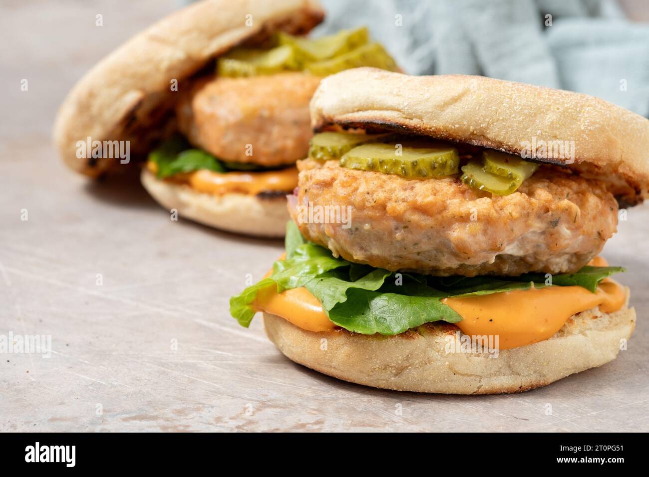 Salmon fishburger english muffin sandwich Stock Photo - Alamy