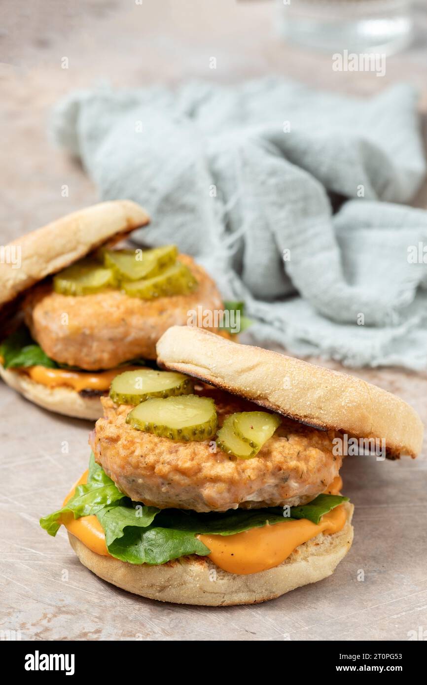 Salmon fishburger english muffin sandwich Stock Photo - Alamy