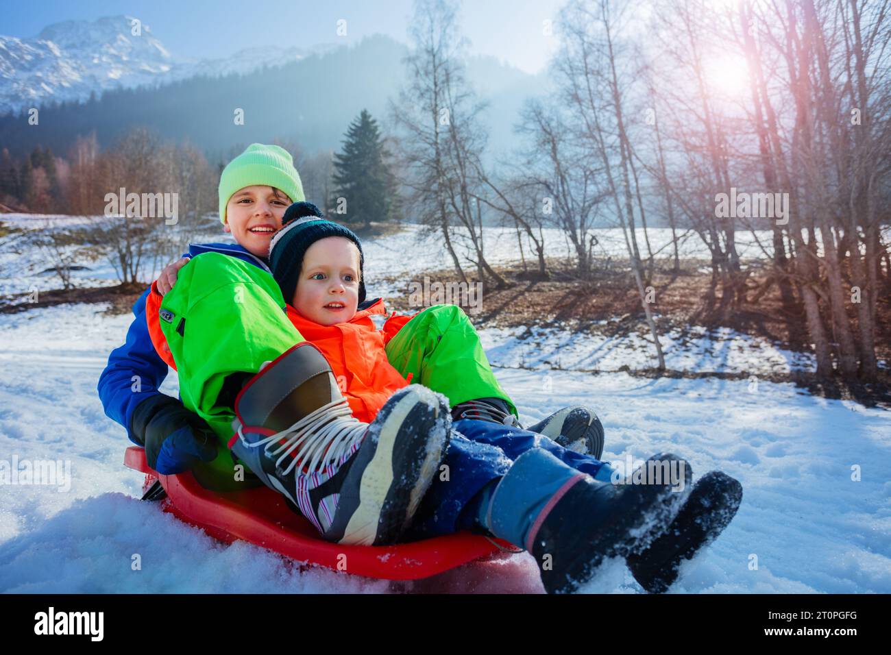 Kids on snow slide hi-res stock photography and images - Alamy