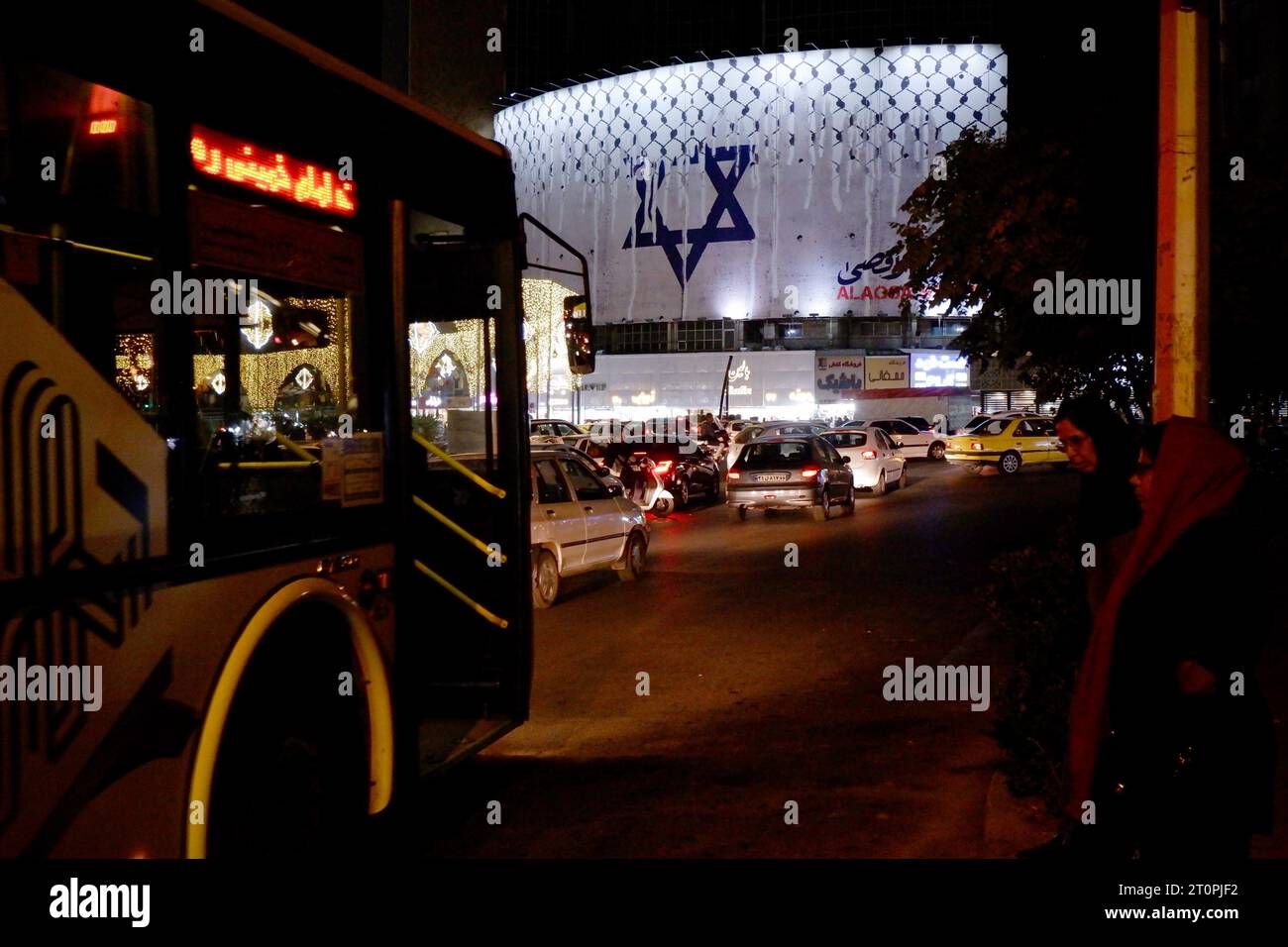 Tehran, Iran. 8th Oct, 2023. People drive past an anti-Israel billboard ...