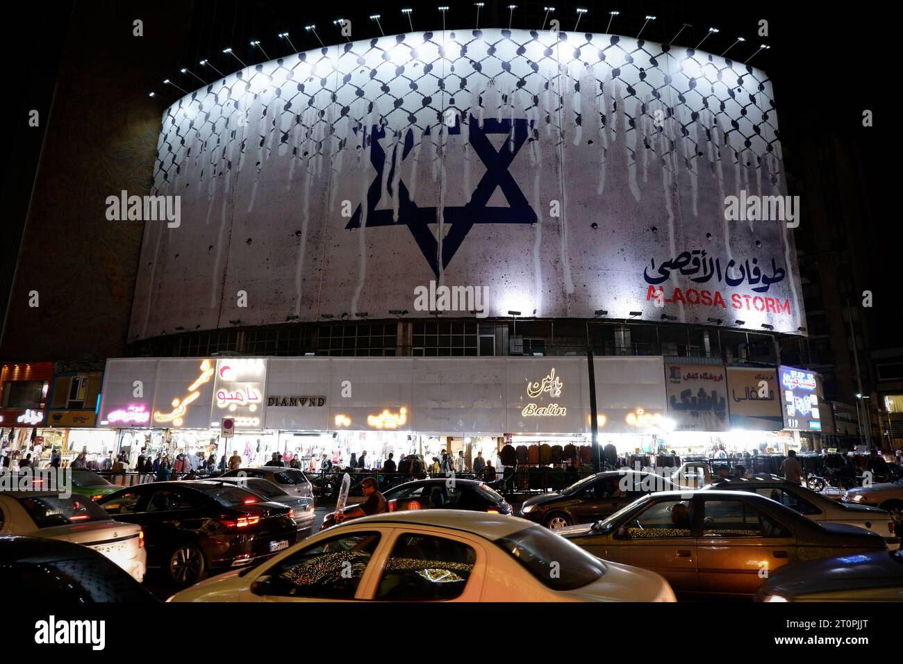 Tehran, Iran. 8th Oct, 2023. People drive past an anti-Israel billboard ...