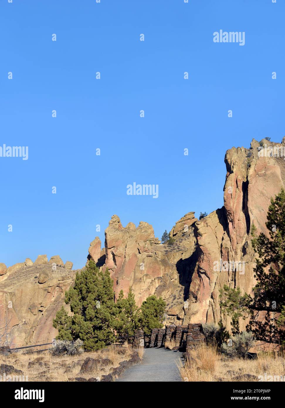 Curving trail, in Smith Rock State Park, in Oregon, has stone pillars ...