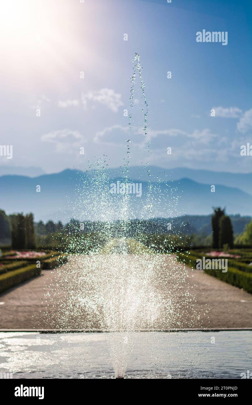 A fountain spewing water into the air. Photo of a beautiful fountain in ...