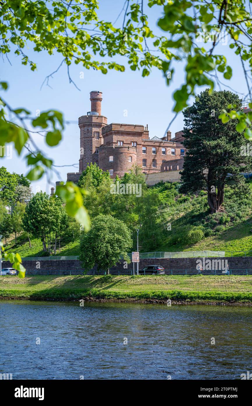 Inverness Castle with tree leaves and river in front, Scotland ...