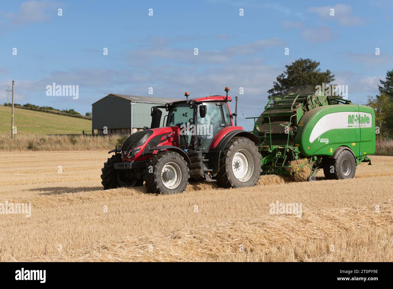 A McHale Fusion Vario Baler Towed by a Red Valtra t195 Tractor Baling ...