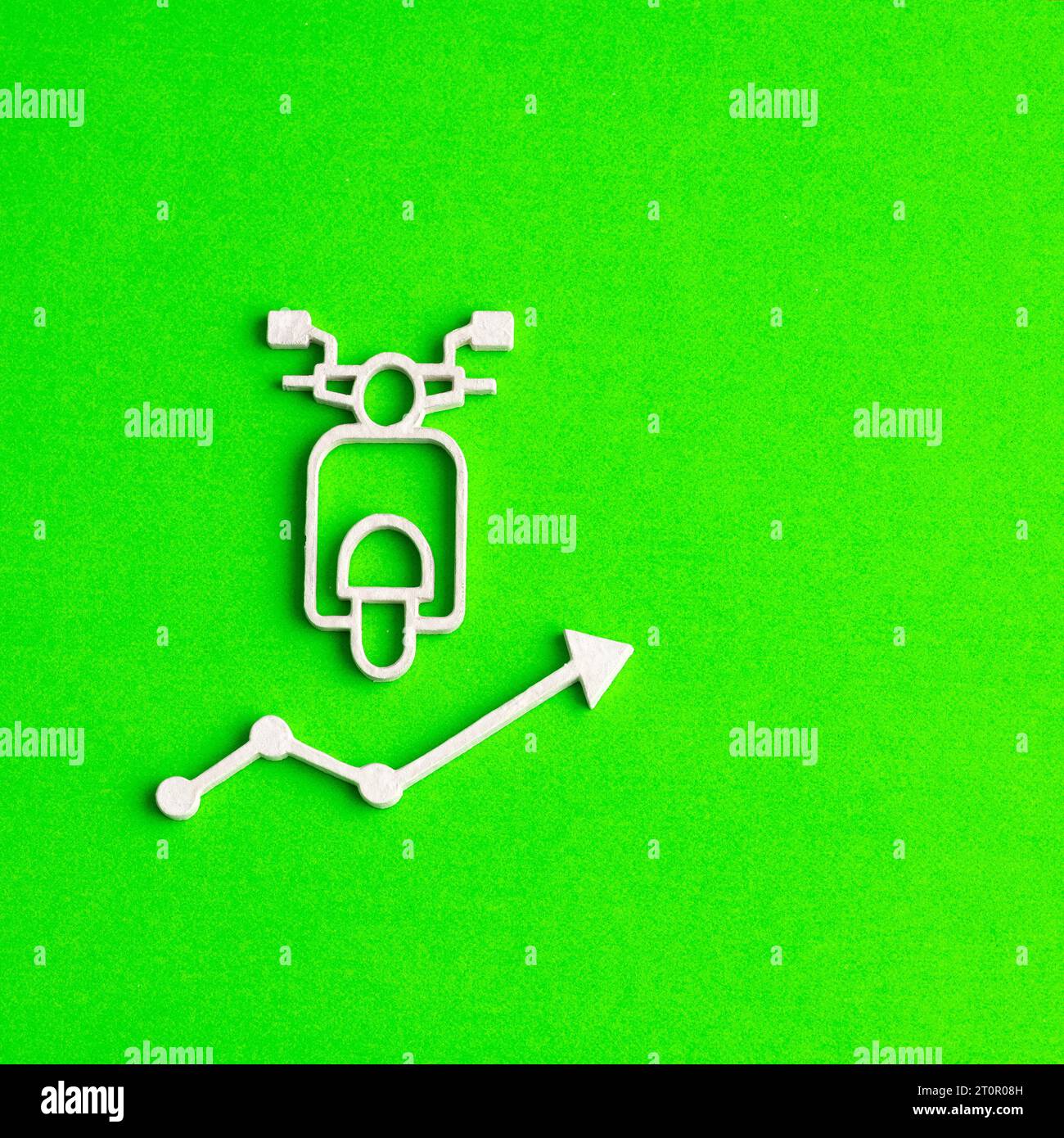 Electric motorcycle with arrow on green background Stock Photo - Alamy