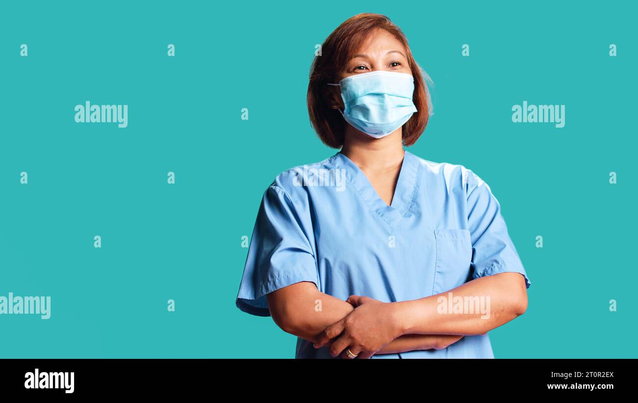 Close up shot of cheerful asian healthcare expert folding her arms ...