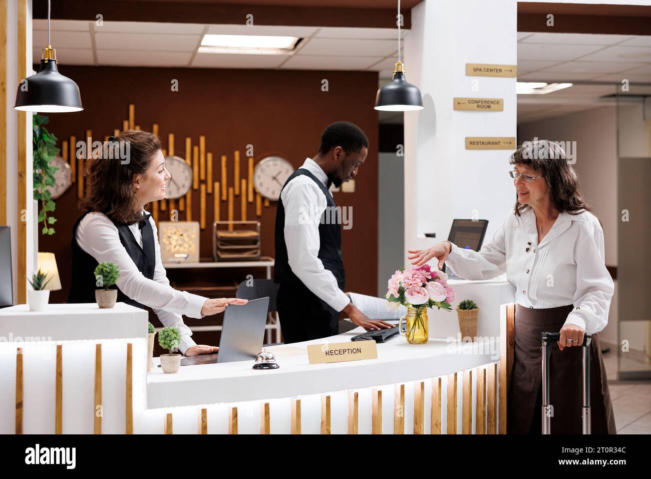Guest arriving checking in man luggage hi-res stock photography and ...
