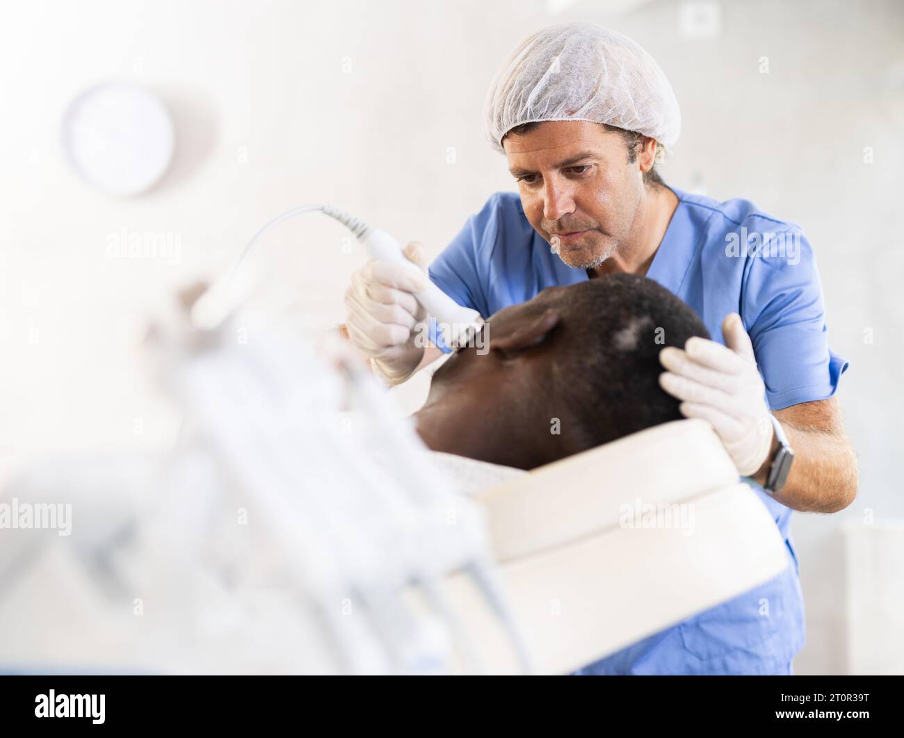 Professional aesthetician administering high frequency ultrasound ... Professional aesthetician administering high frequency ultrasound ...