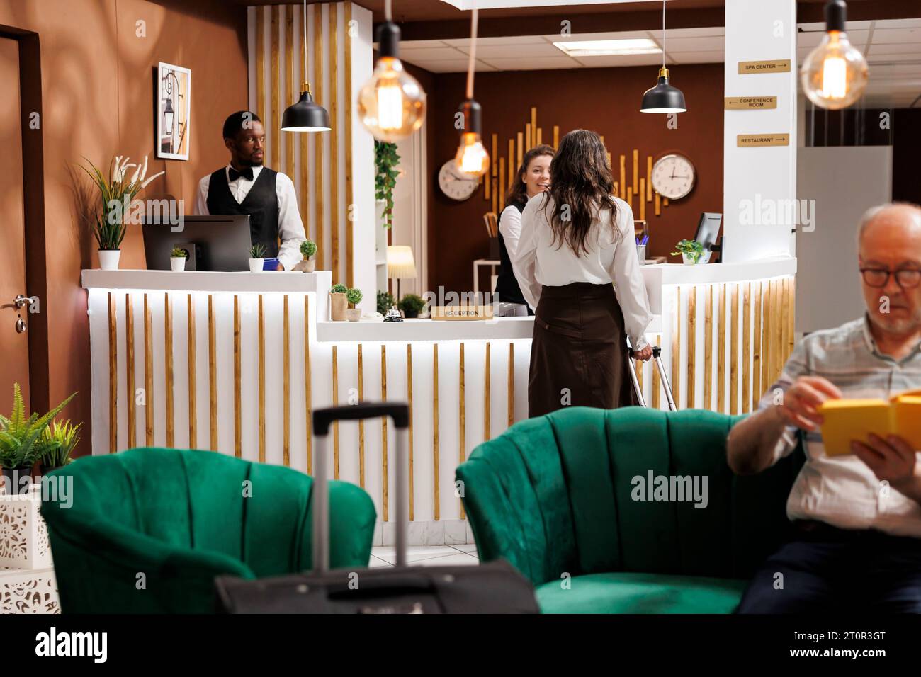 Caucasian female receptionist assisting guest hi-res stock photography ...