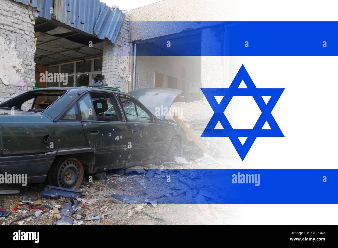 A destroyed civilian car against the background of the Israeli flag ...