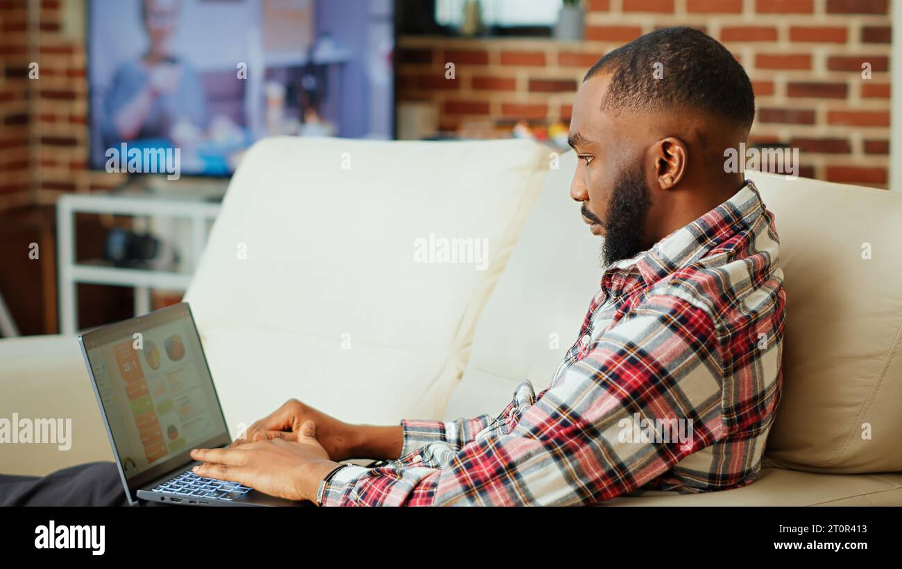 Remote Employee Using Online Analytics Statistical Data Charts To