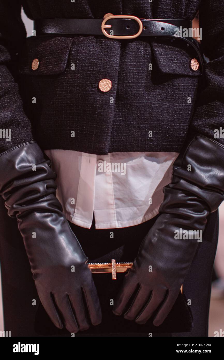 Fashion details of a classy black jacket, leather belt, gloves and ...