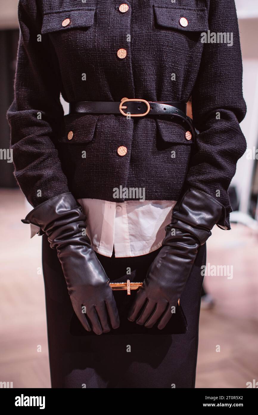 Fashion details of a classy black jacket, leather belt, gloves and ...