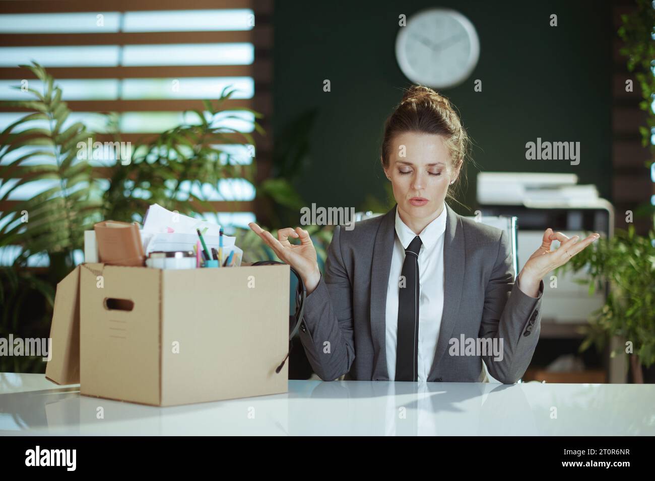 New job. stressed modern 40 years old woman employee in modern green ...