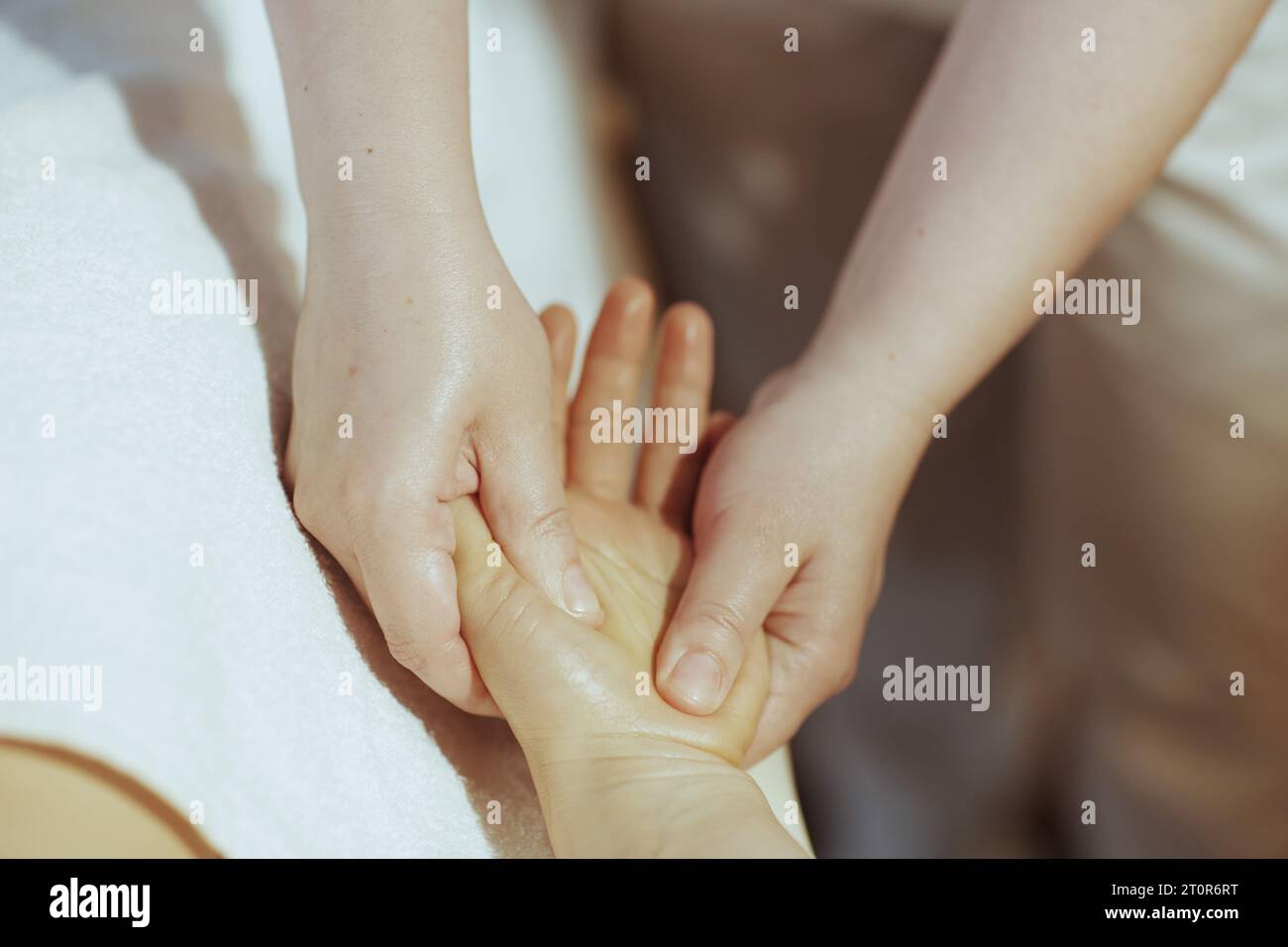 Healthcare time. Closeup on massage therapist in massage cabinet massaging clients hand Stock ...