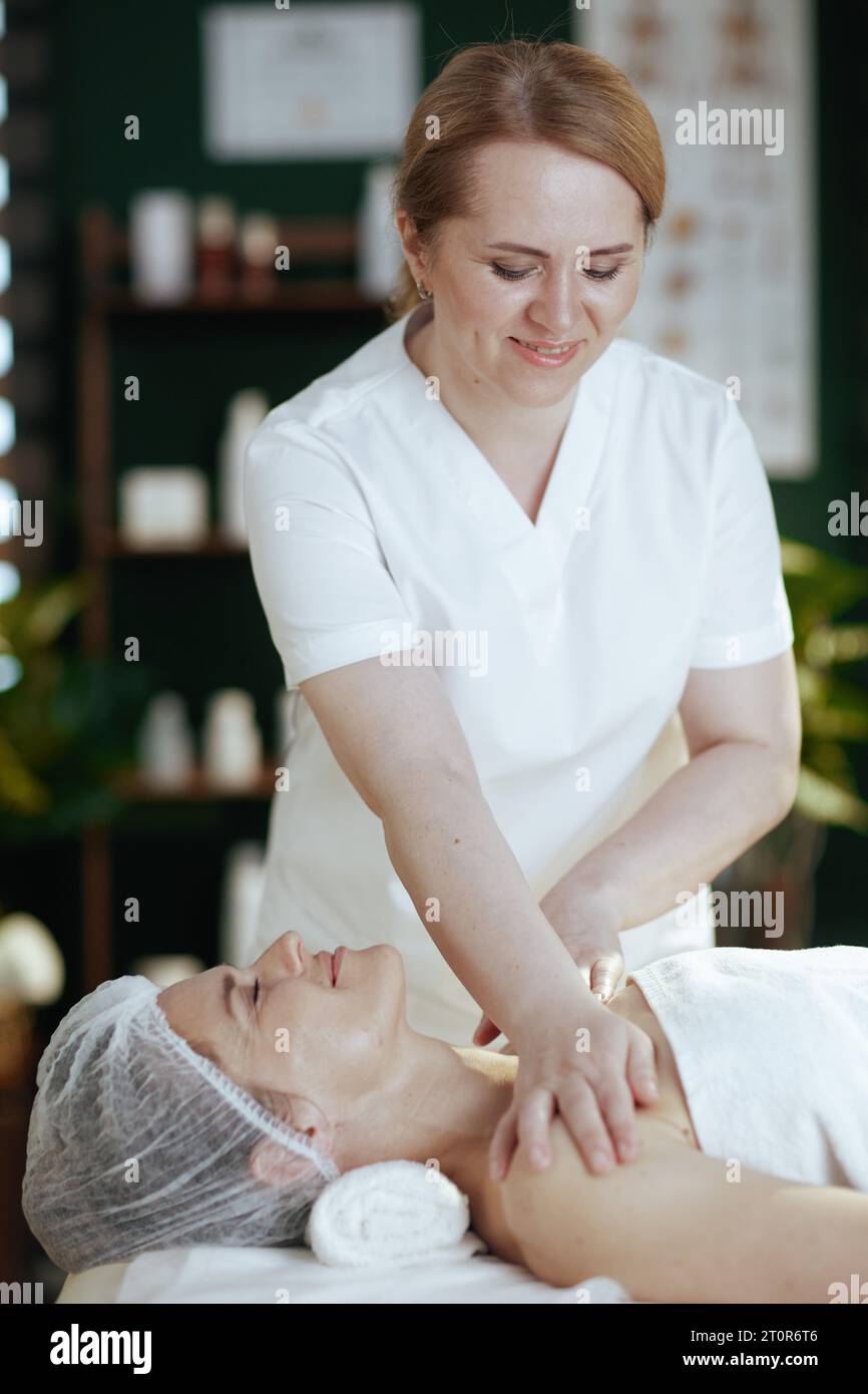 Healthcare time. massage therapist in spa salon massaging clients shoulder Stock Photo - Alamy